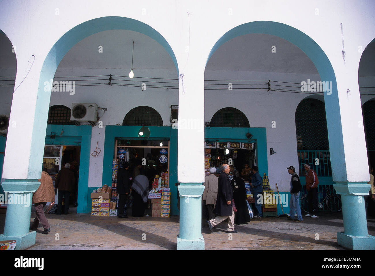 Libya Tripoli people shopping in shops set behind arcades framed with ...