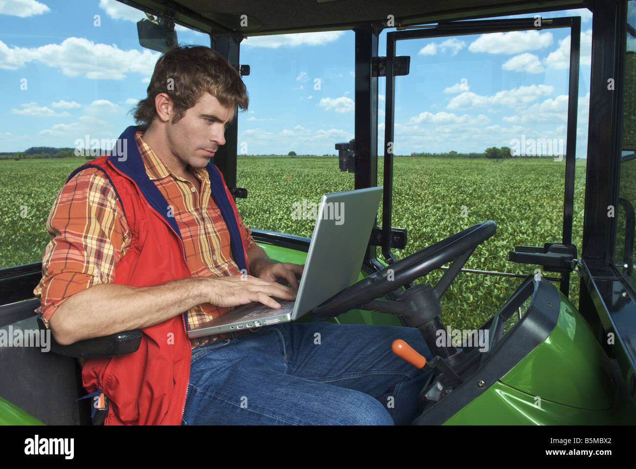Farmer sitting on a tractor hi-res stock photography and images - Alamy