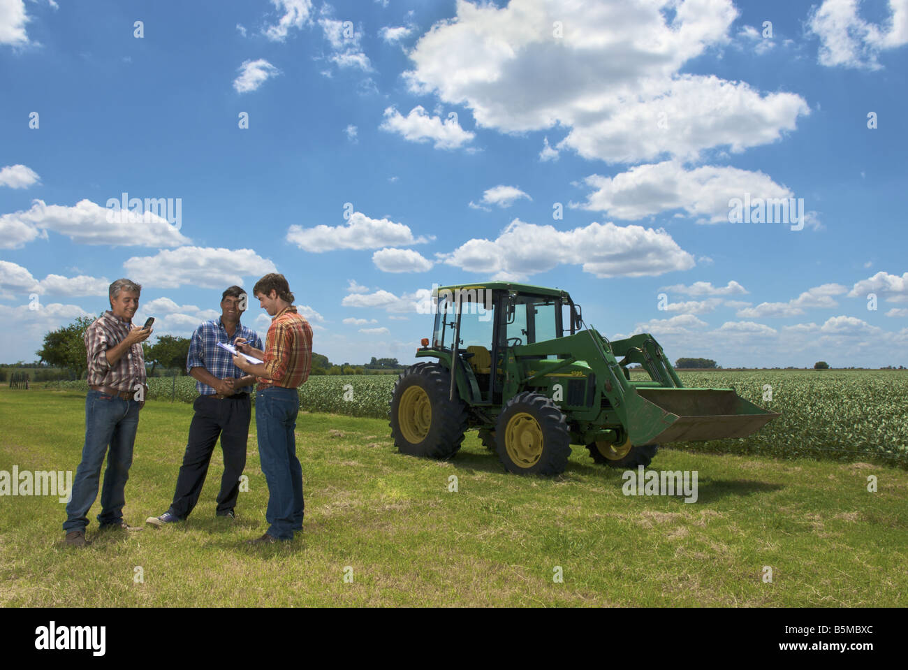 Three men at a farm Stock Photo - Alamy