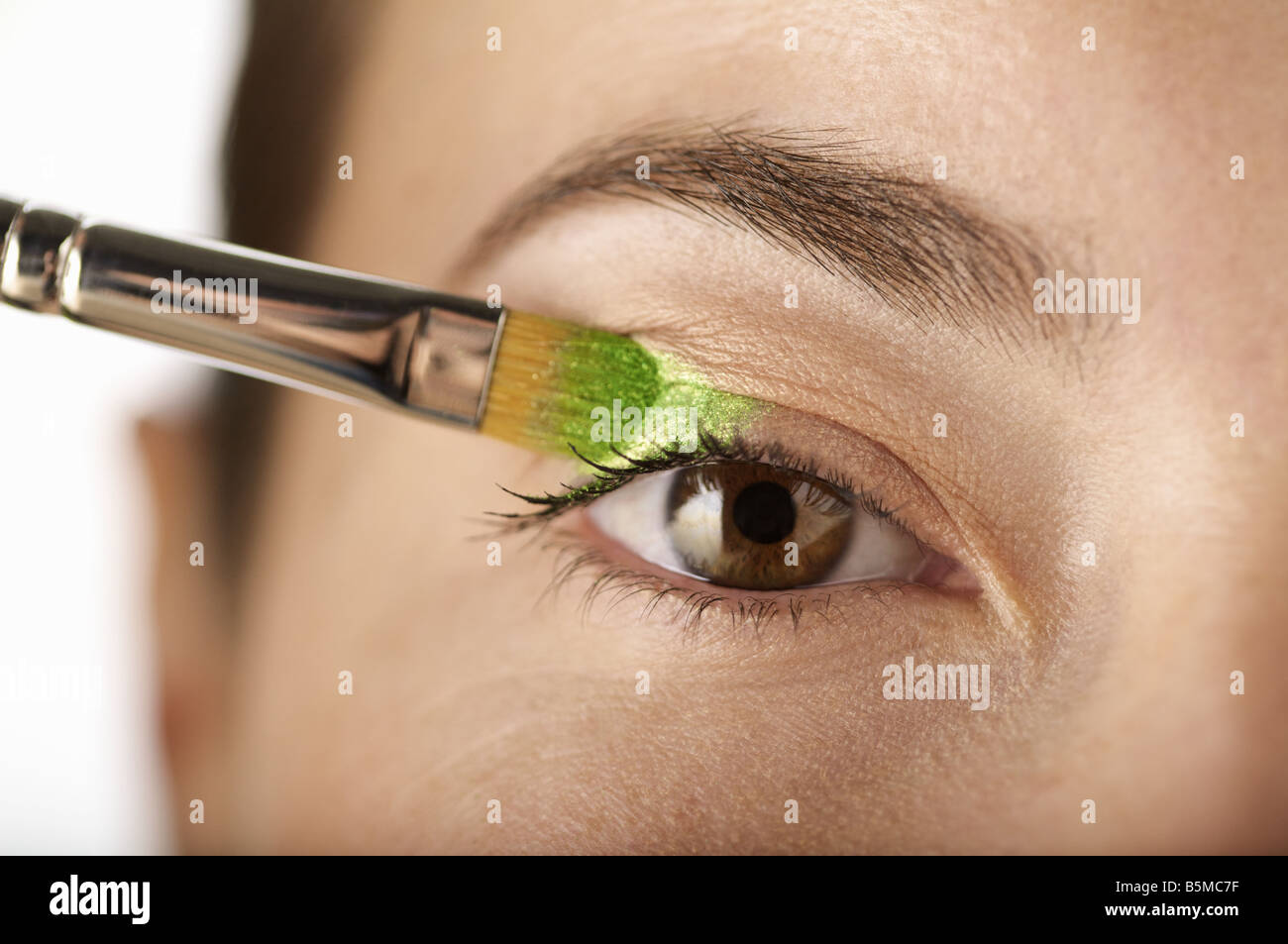 A woman having eyeshadow applied with a brush Stock Photo - Alamy