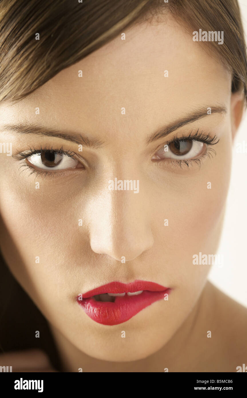 A woman biting her lip Stock Photo - Alamy