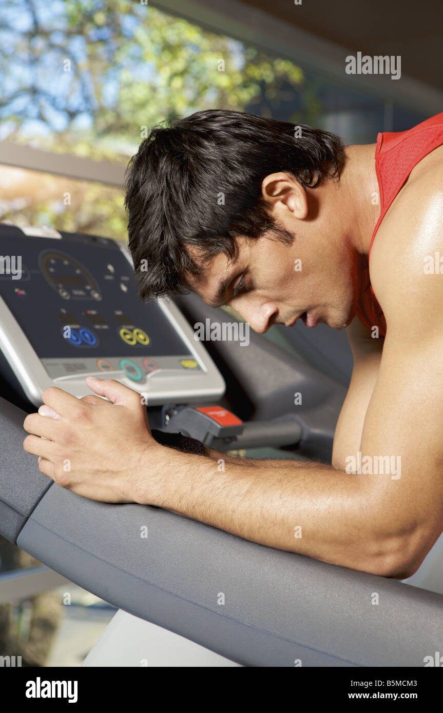 A man exhausted from exercising on a treadmill Stock Photo - Alamy
