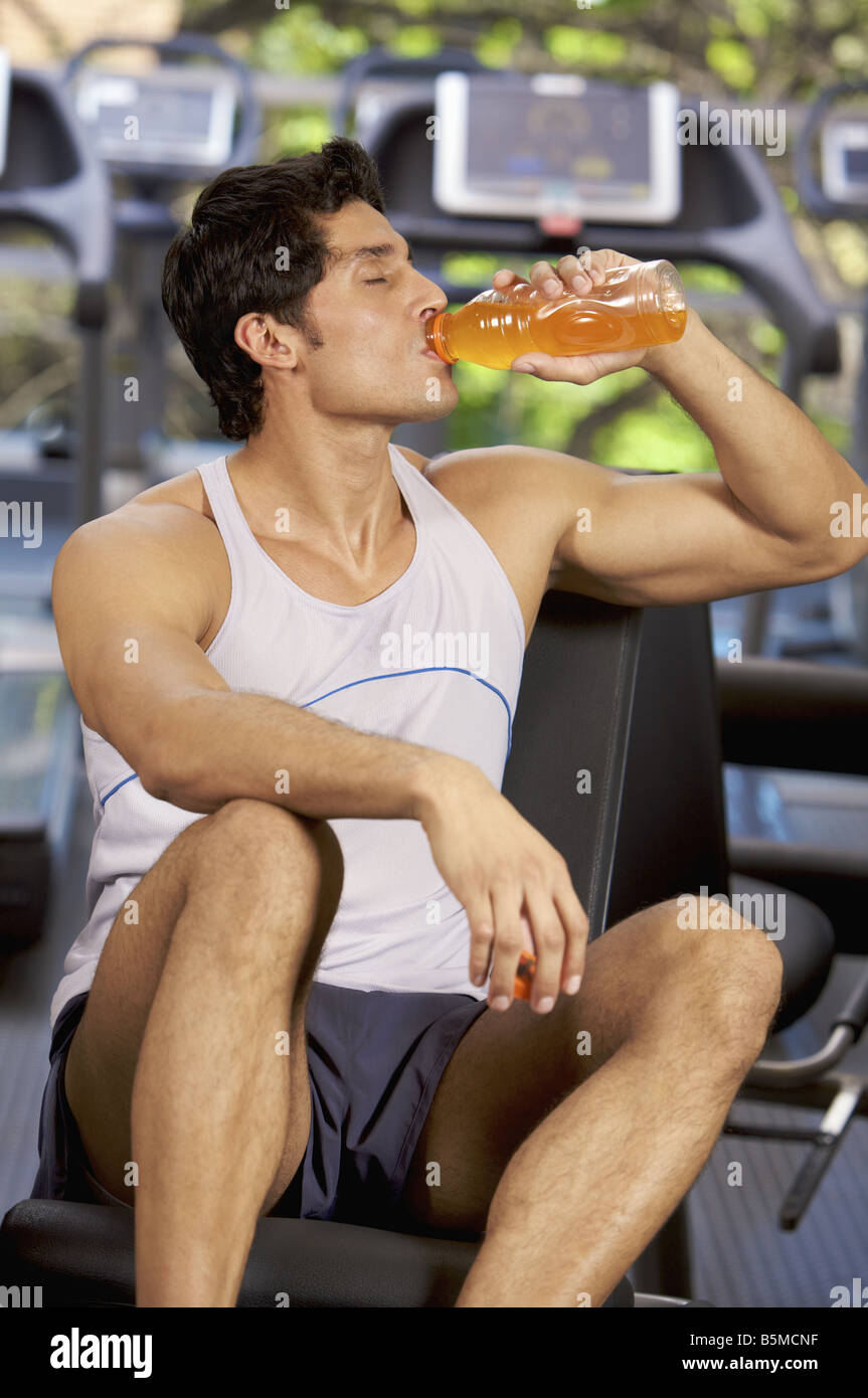 A man drinking a spots drink Stock Photo - Alamy