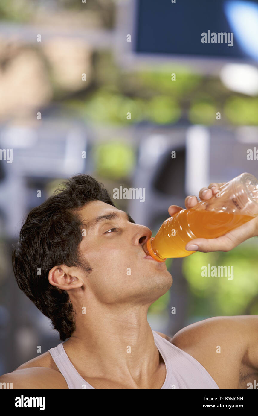 A man drinking a spots drink Stock Photo - Alamy