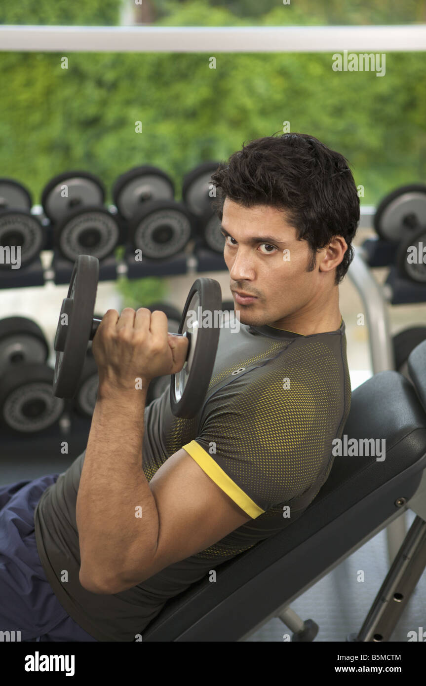 A man exercising with dumbbells Stock Photo - Alamy