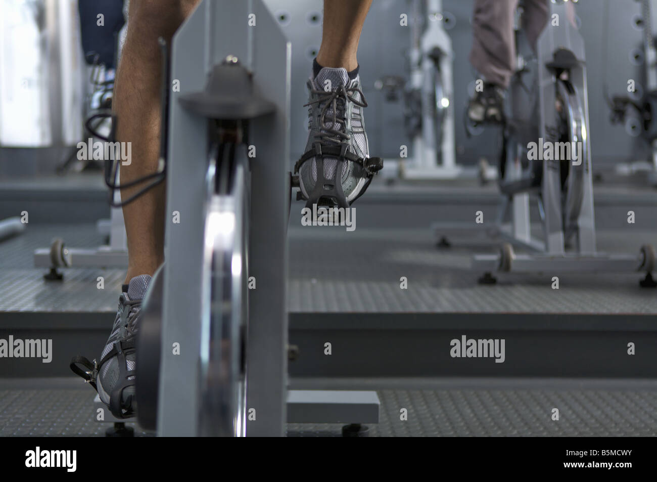 A man's feet on the pedals of a stationary bicycle Stock Photo - Alamy