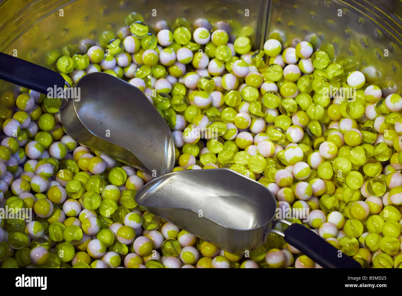 A bucket of glass marbles with scoops Stock Photo - Alamy