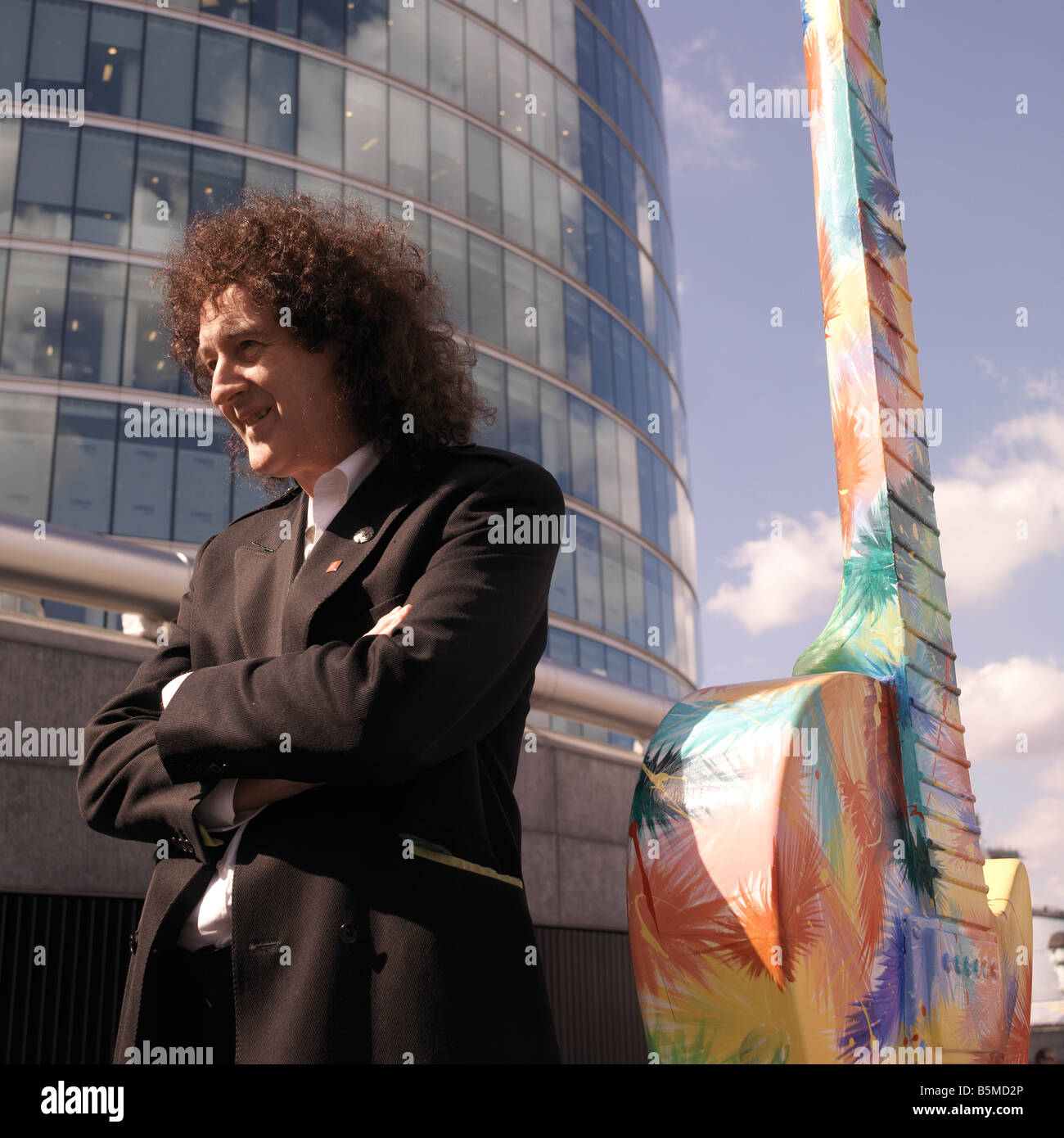 guitarist Brian May standing by a large model of a guitar Stock Photo ...