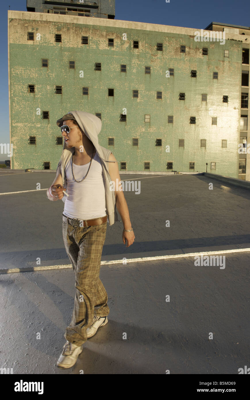 A young man walking on a roof Stock Photo - Alamy
