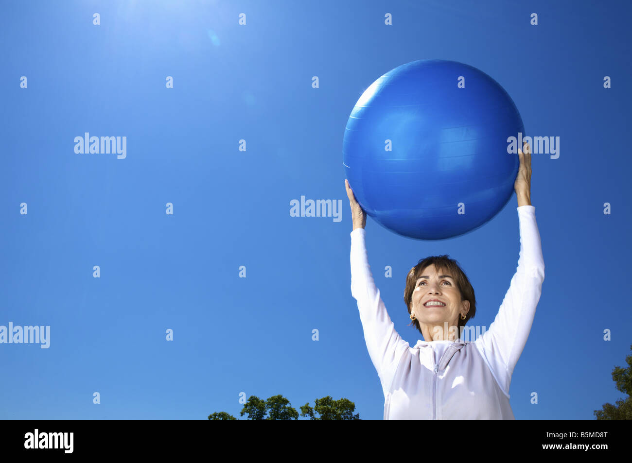An elderly woman holding an exercise ball Stock Photo - Alamy