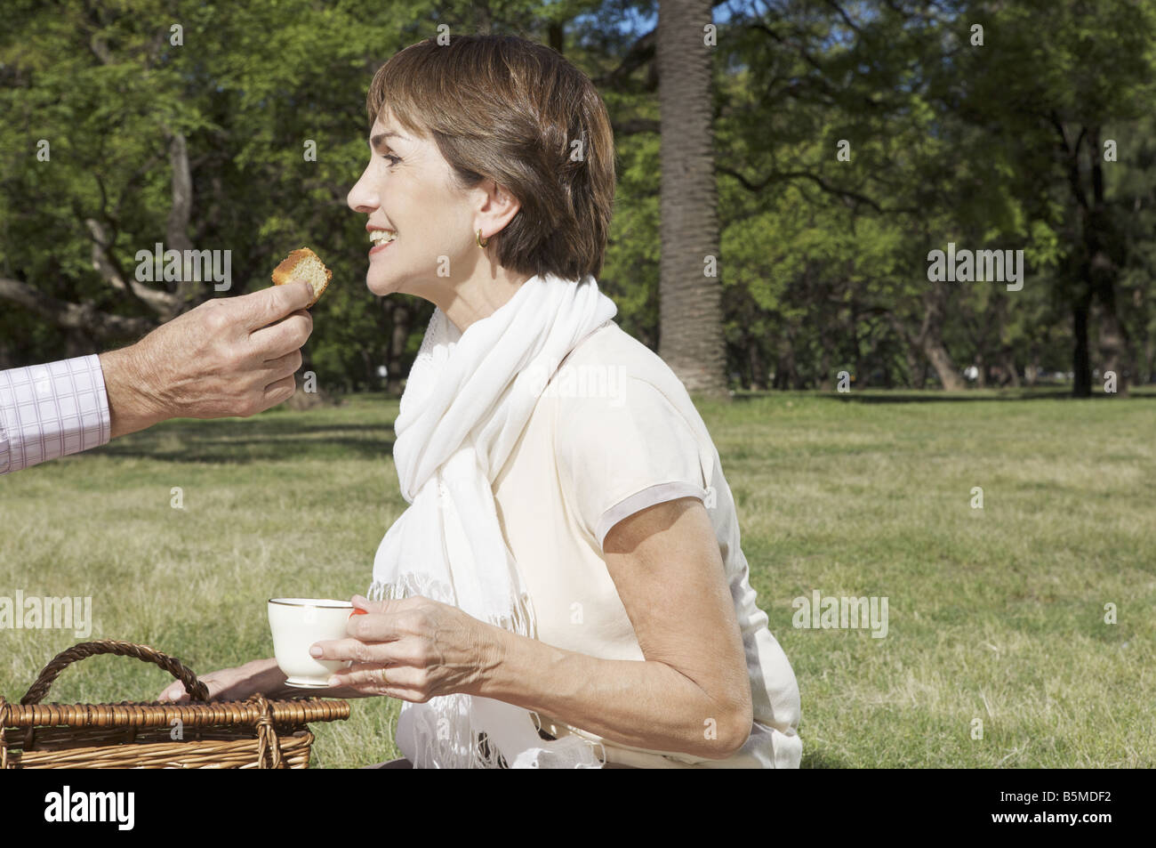 Seated woman feeding hi-res stock photography and images - Alamy