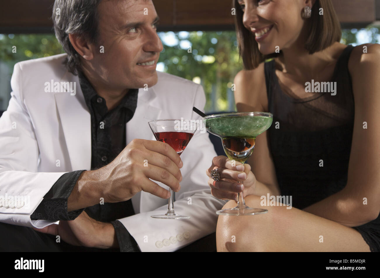 A couple having cocktails Stock Photo - Alamy