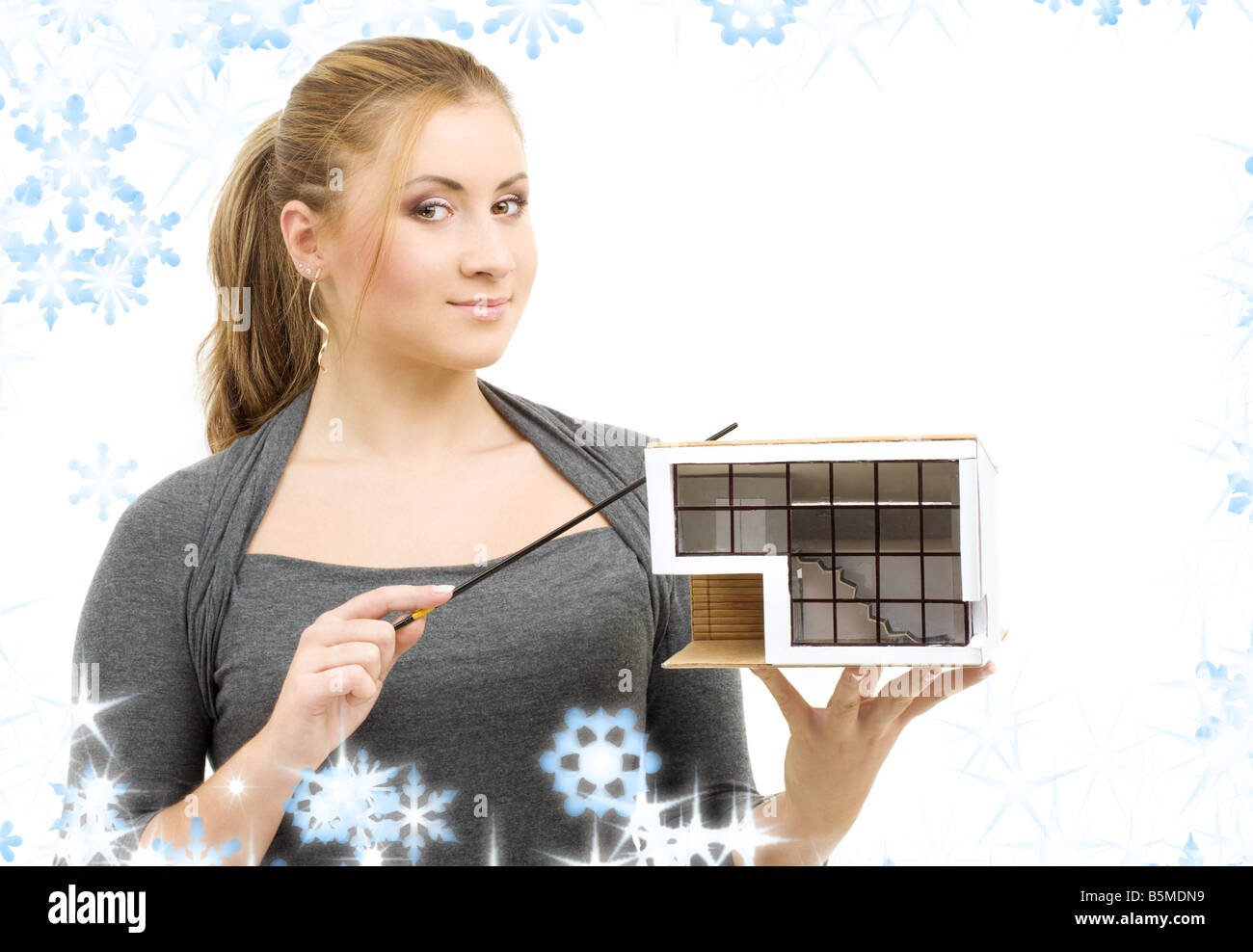 lovely lady with small house model and pointer in hands Stock Photo - Alamy