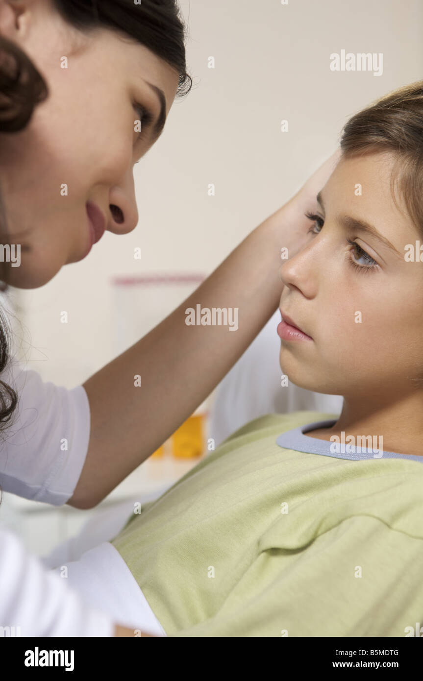 A little boy being comforted by a woman Stock Photo - Alamy