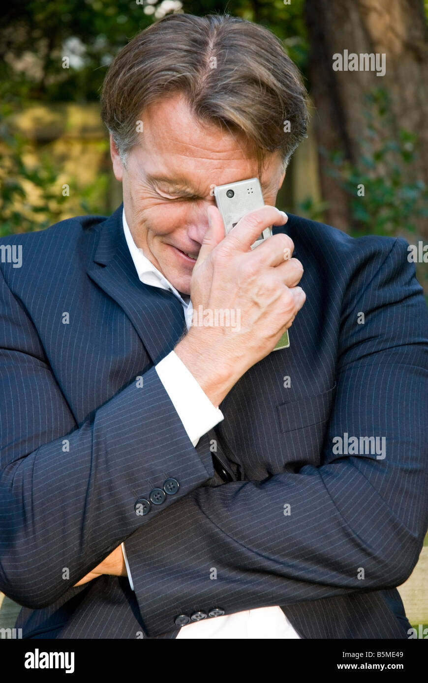A depressed and desperate looking businessman holds back the tears ...