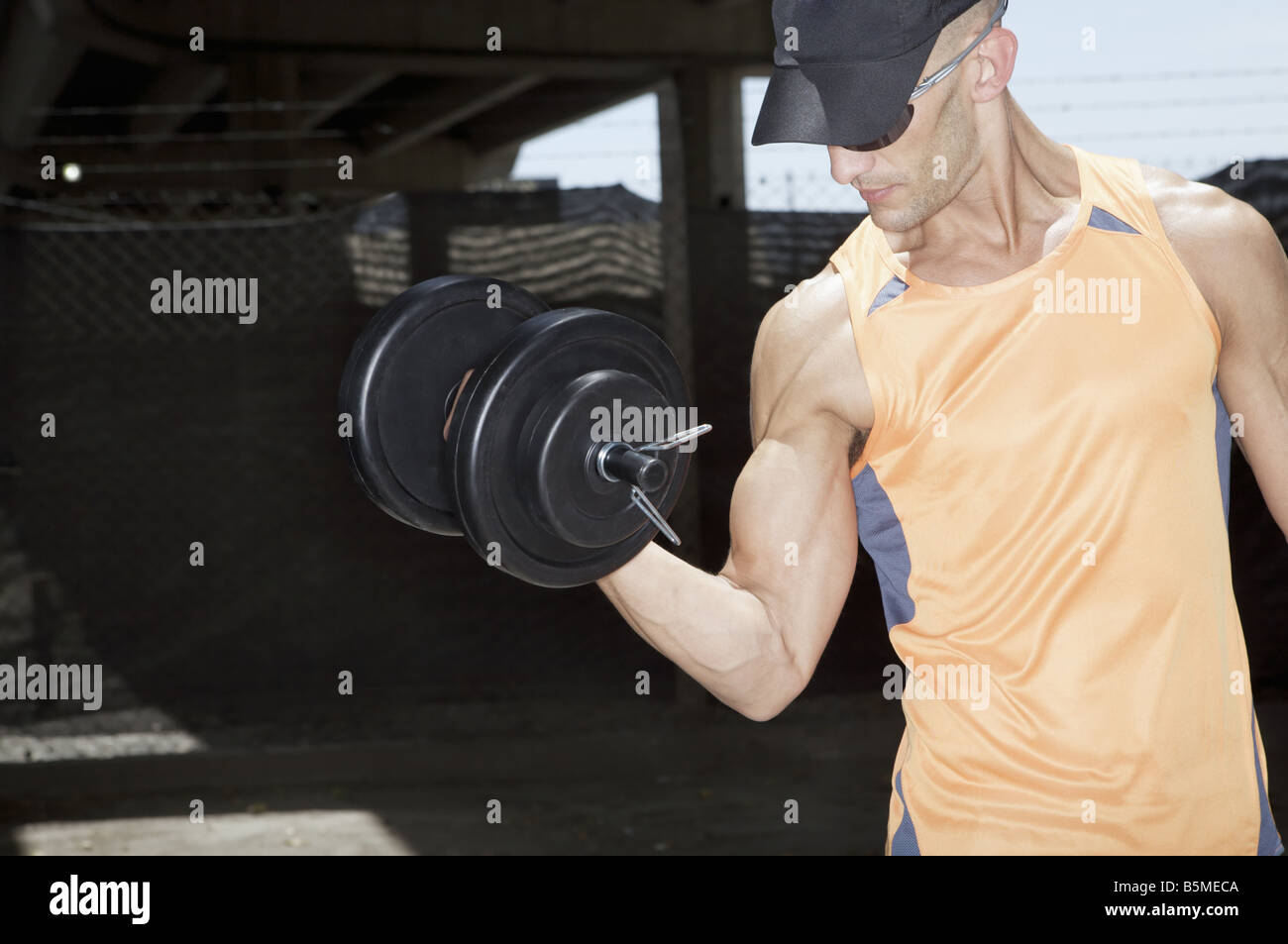 A man lifting a dumbell Stock Photo - Alamy