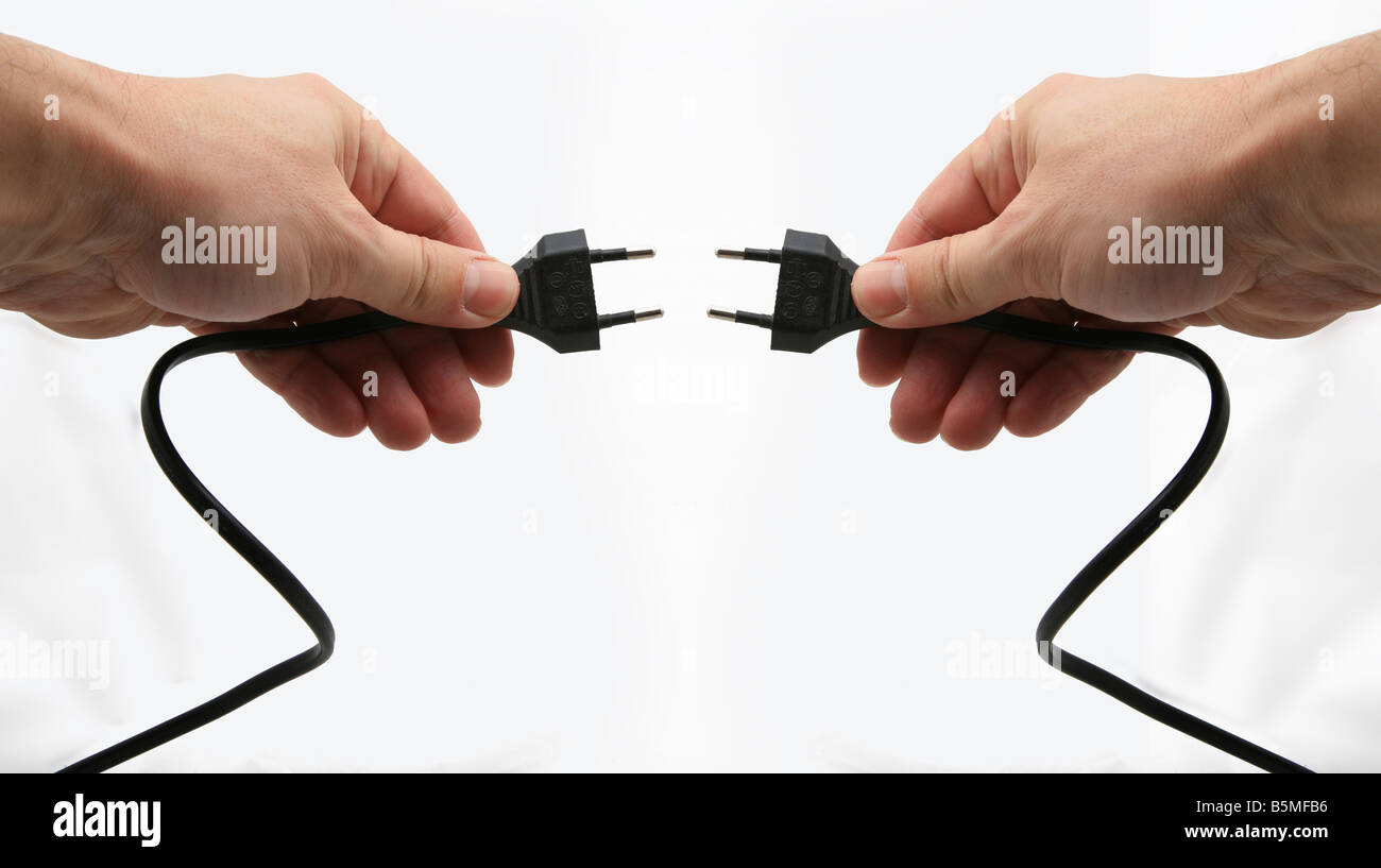 hand holding an electrical plug Stock Photo - Alamy