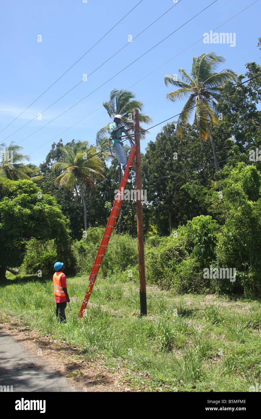 man with helmet working on a pole with electrical wire in Tobago Stock ...