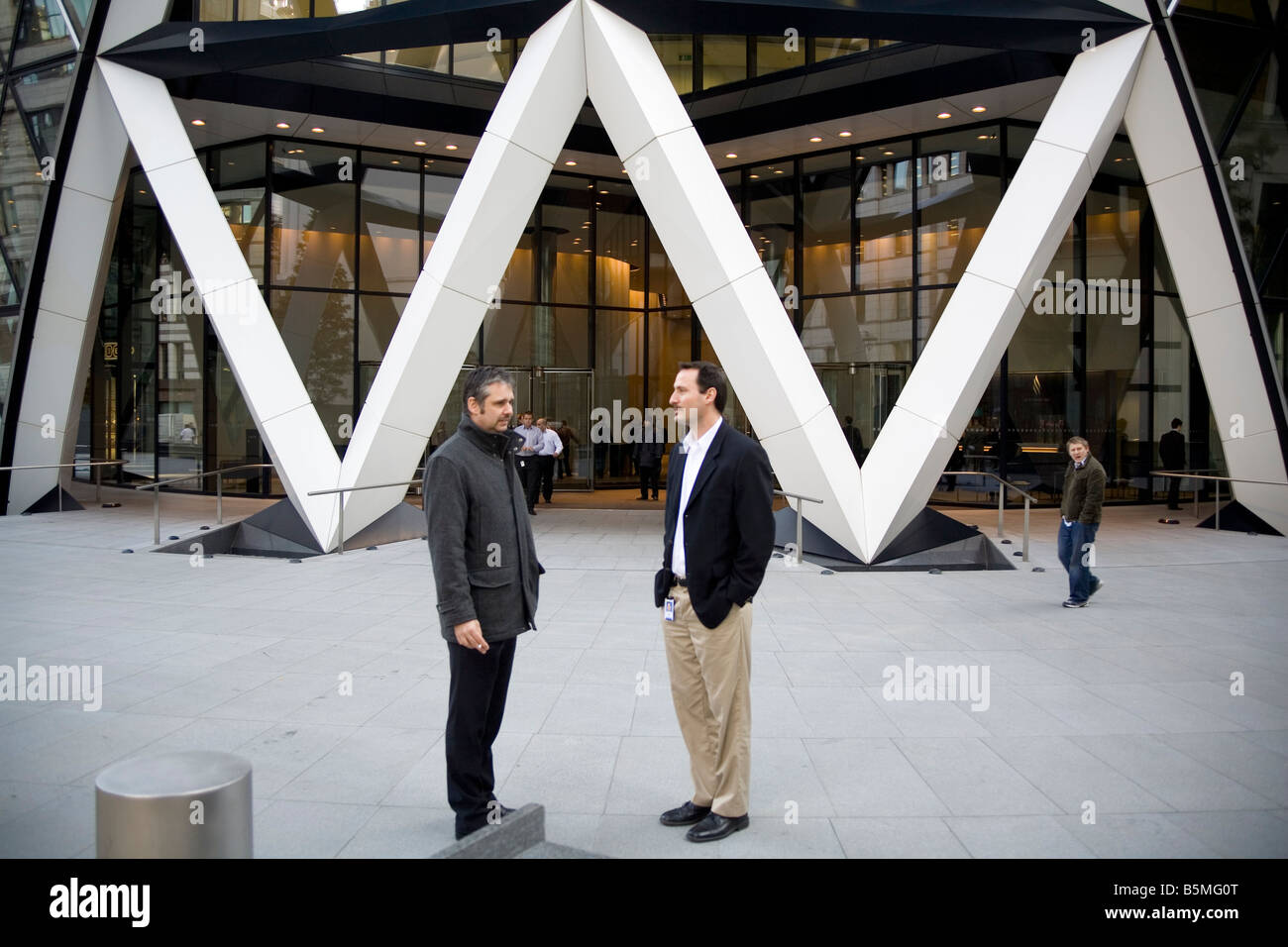 Gherkin entrance people building stand hi-res stock photography and ...