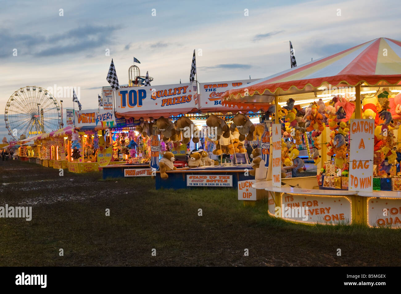Game stalls and rides at a funfair (specifically at The Hoppings ...