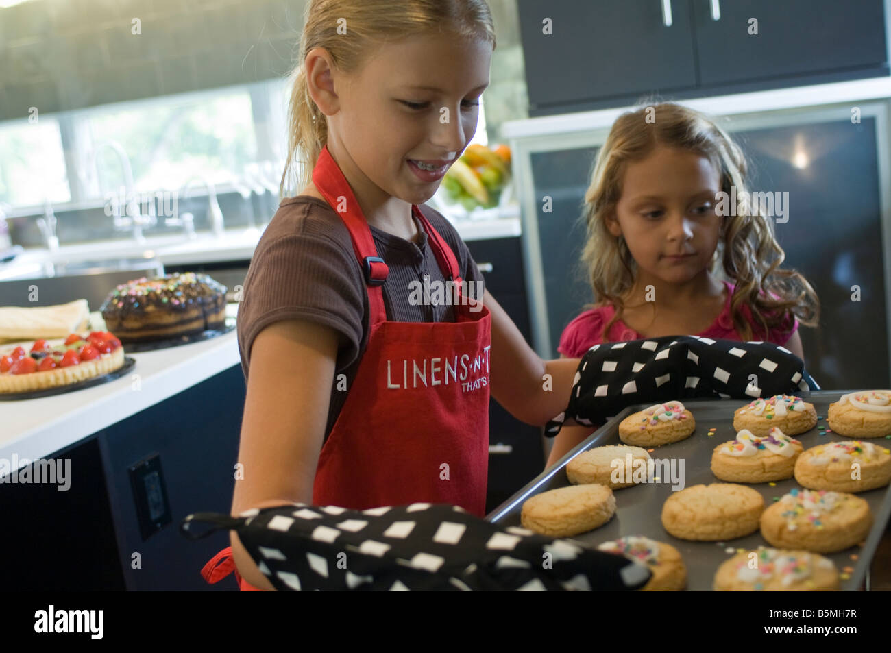 2 young sisters baking together Stock Photo - Alamy