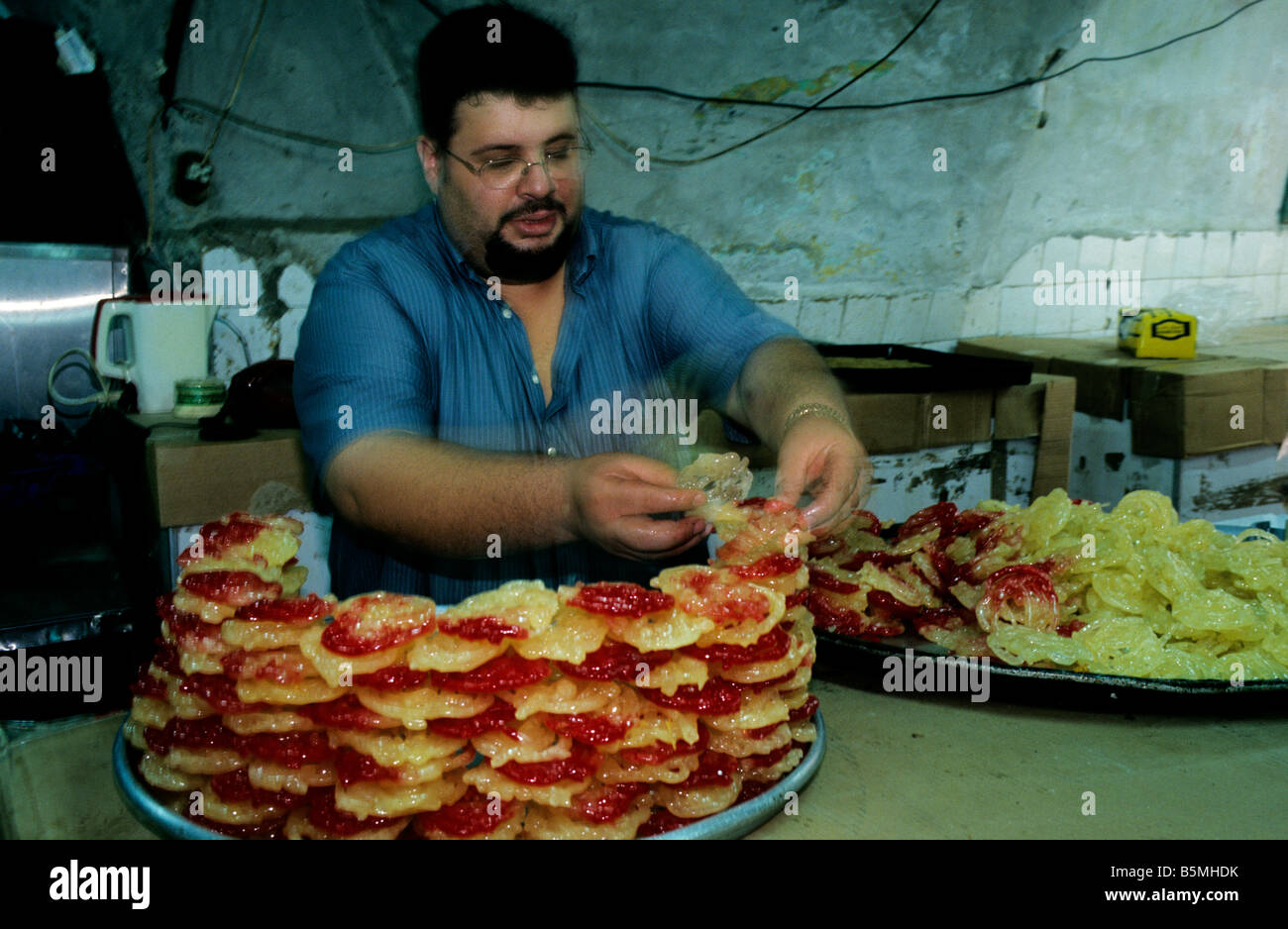 A chef prepares a display of Arabic sweets in a patisserie in Sidon's ...