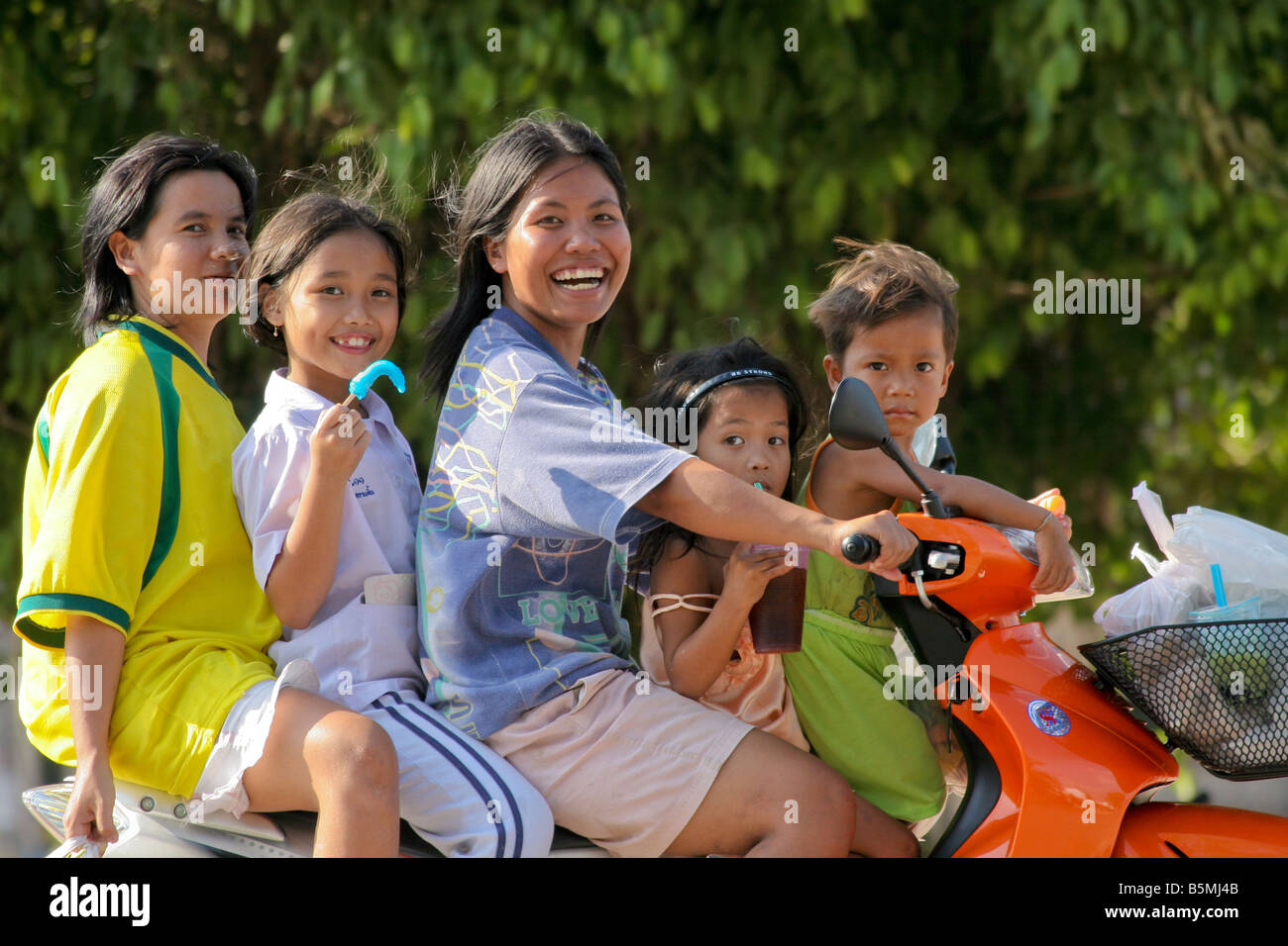 Thai family riding a motorcycle hi-res stock photography and images - Alamy