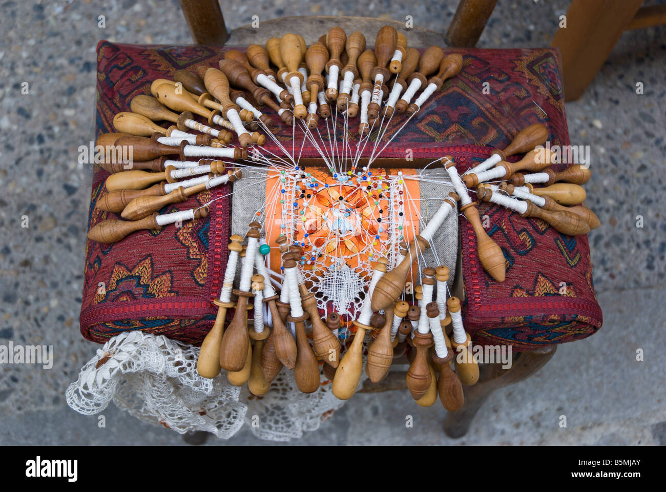Intricate lace work sits on display on a chair along the street in Le ...