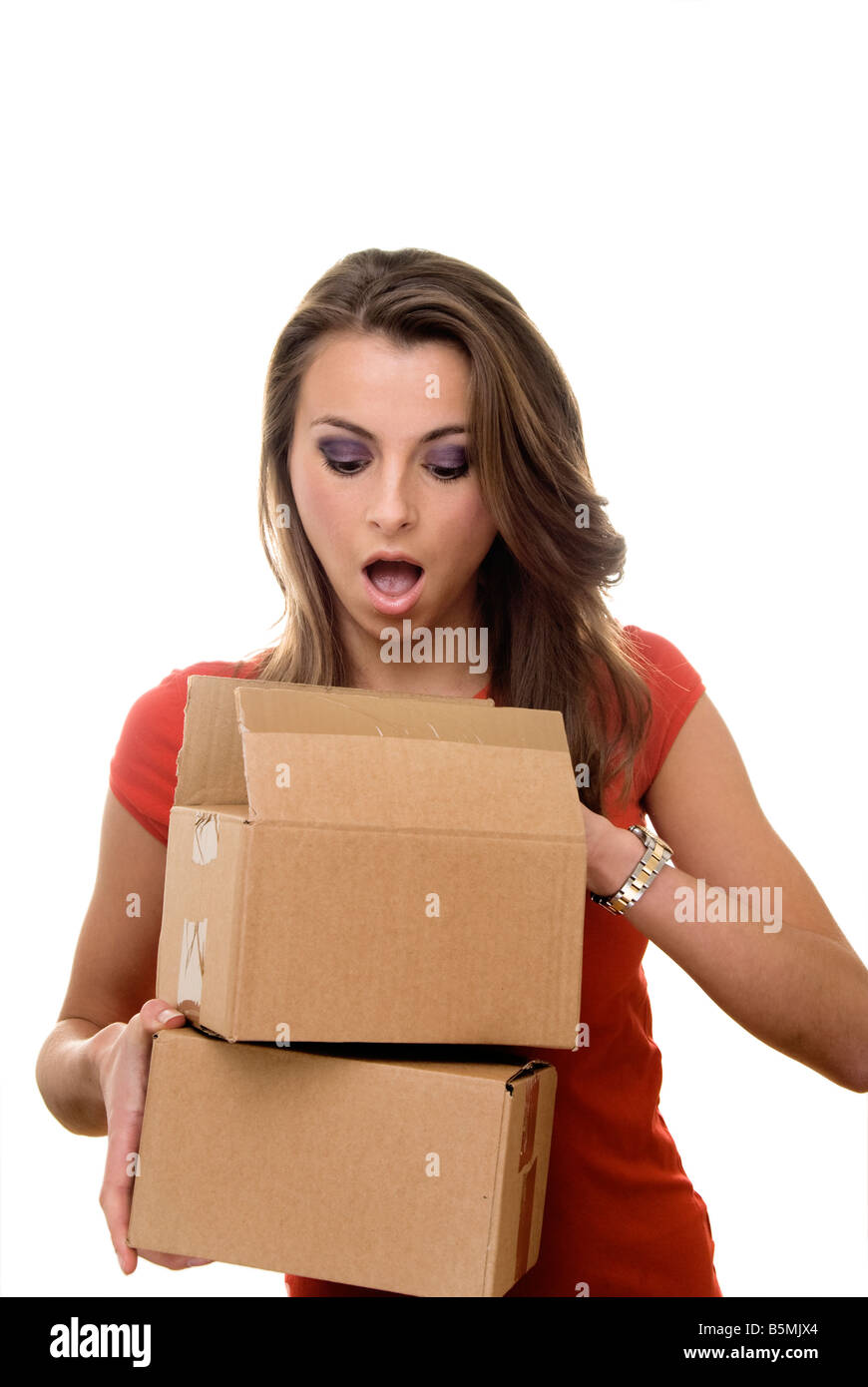 woman opening a cardboard box and looking shocked or surprised Stock ...
