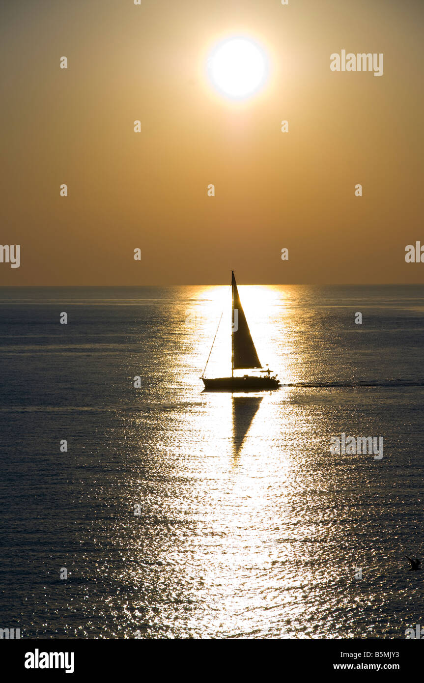 A sailboat navigating in the water with sunlight Stock Photo - Alamy