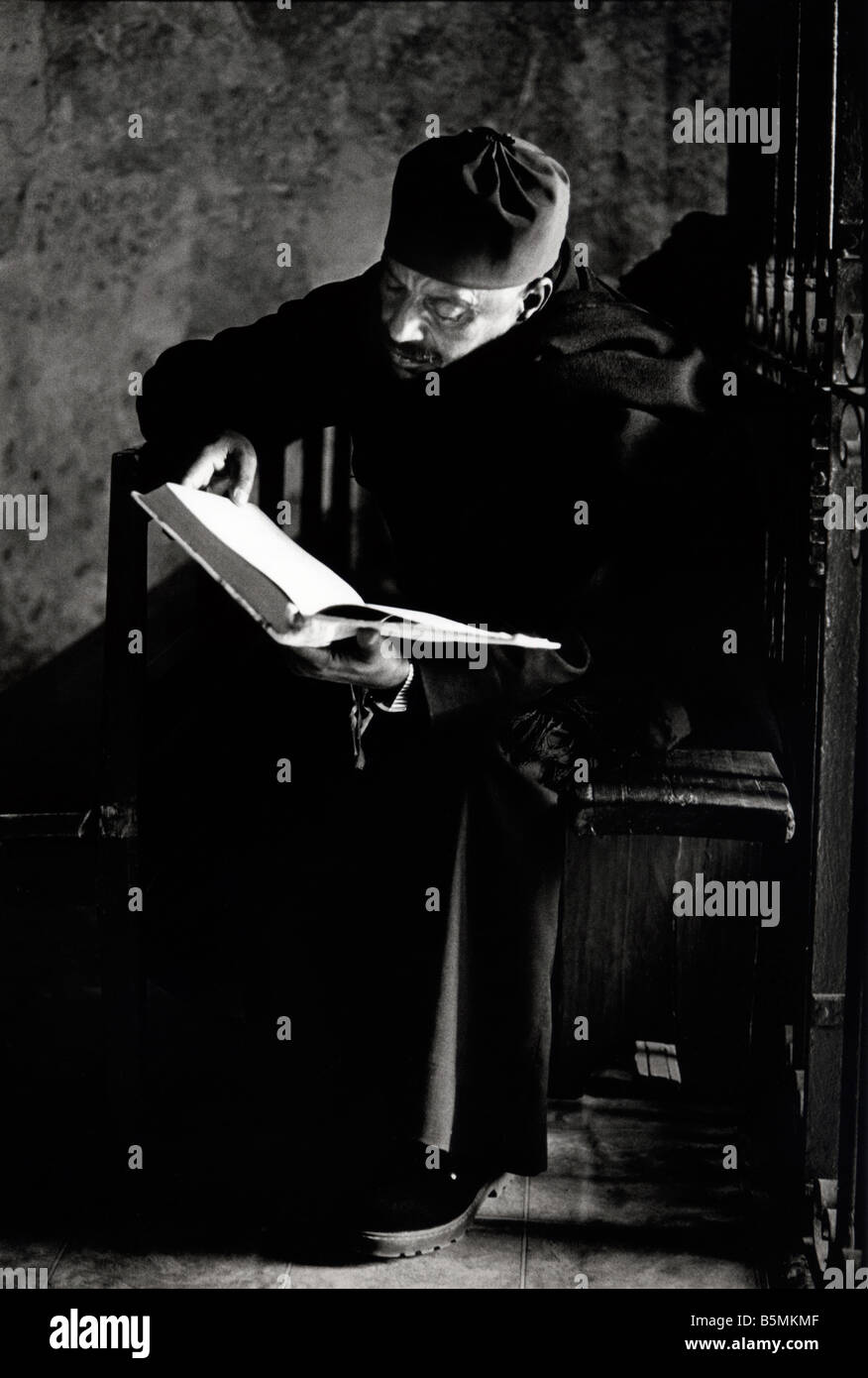 A monk reads the bible, Ethiopian Orthodox Monastery built on the roof ...