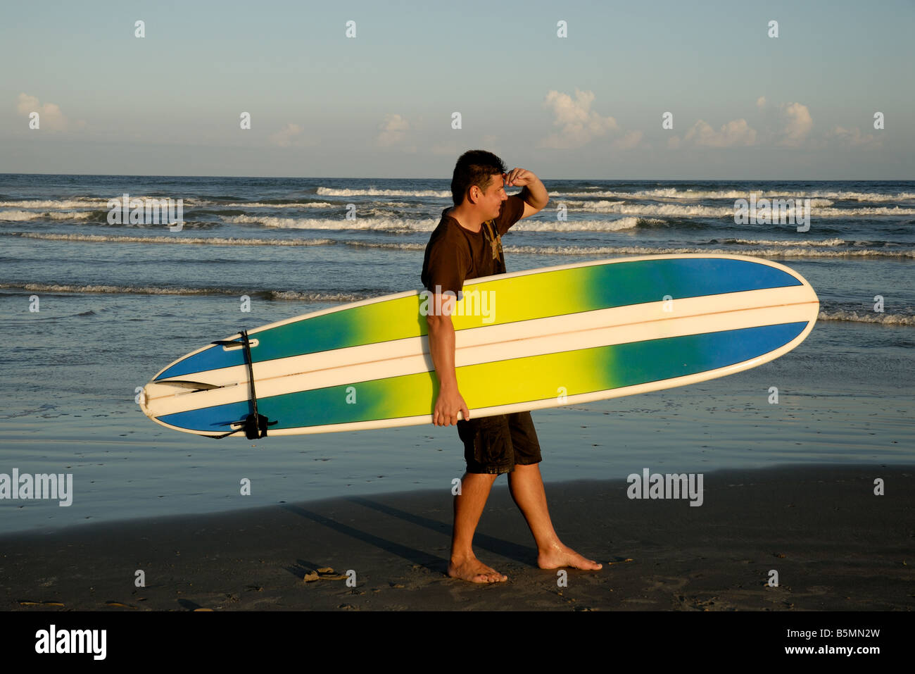 Surfer on the beach Stock Photo - Alamy