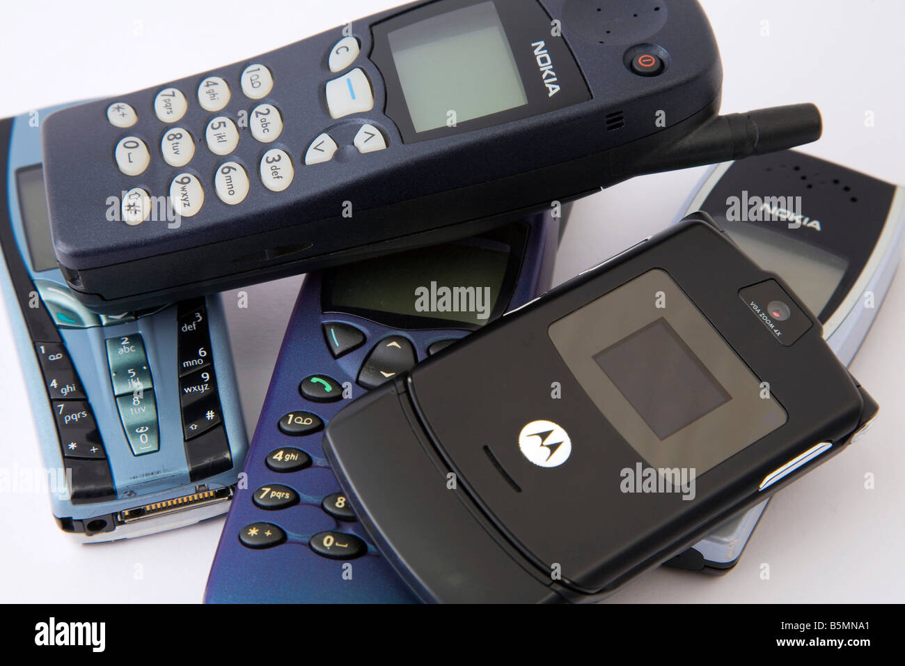 Random pile of five old mobile telephones on a white background Stock ...