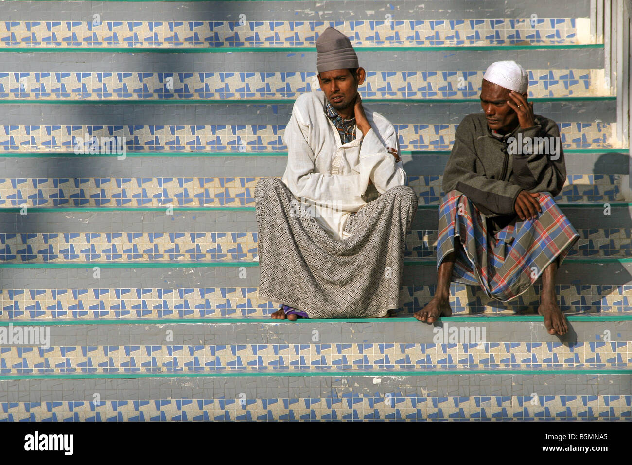 two muslims seated on mosque stairs, mae sot village, umphang province ...