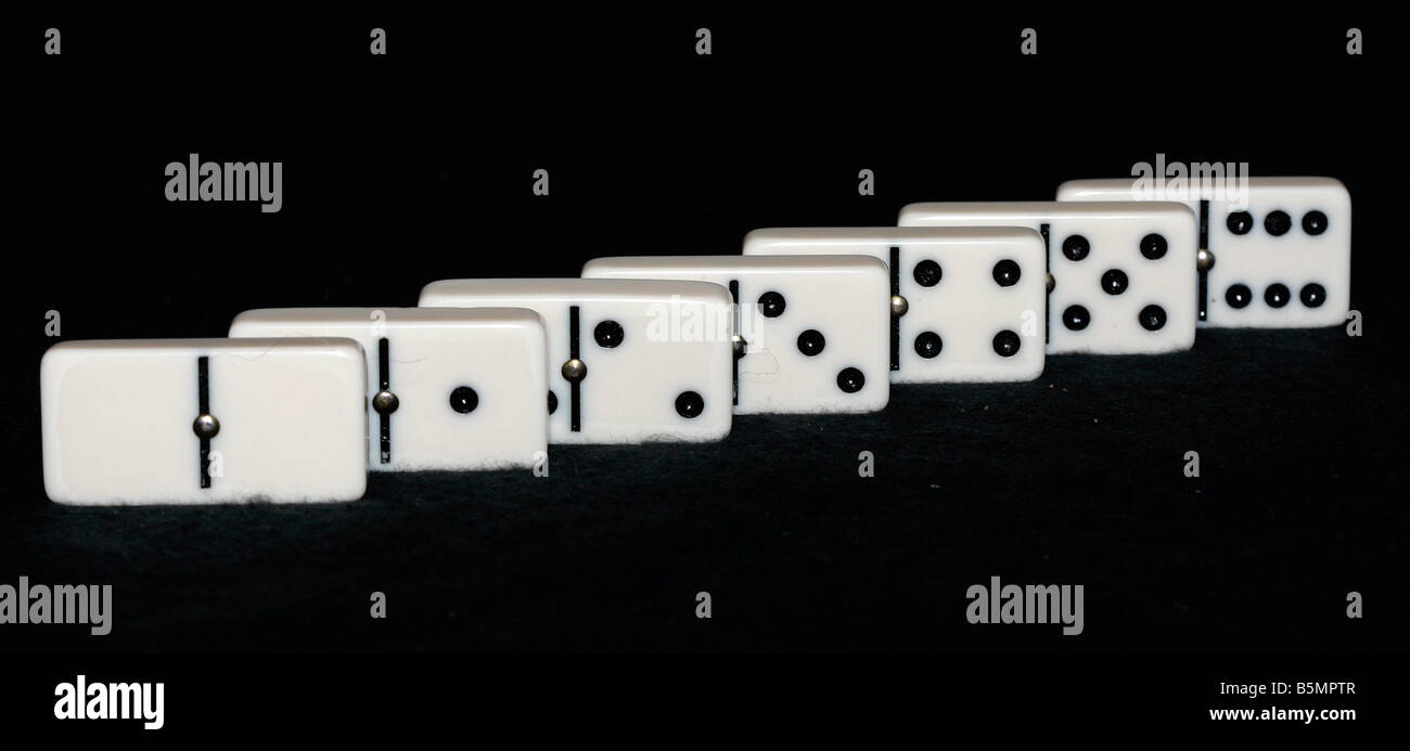 seven dominos arranged in a line Stock Photo - Alamy
