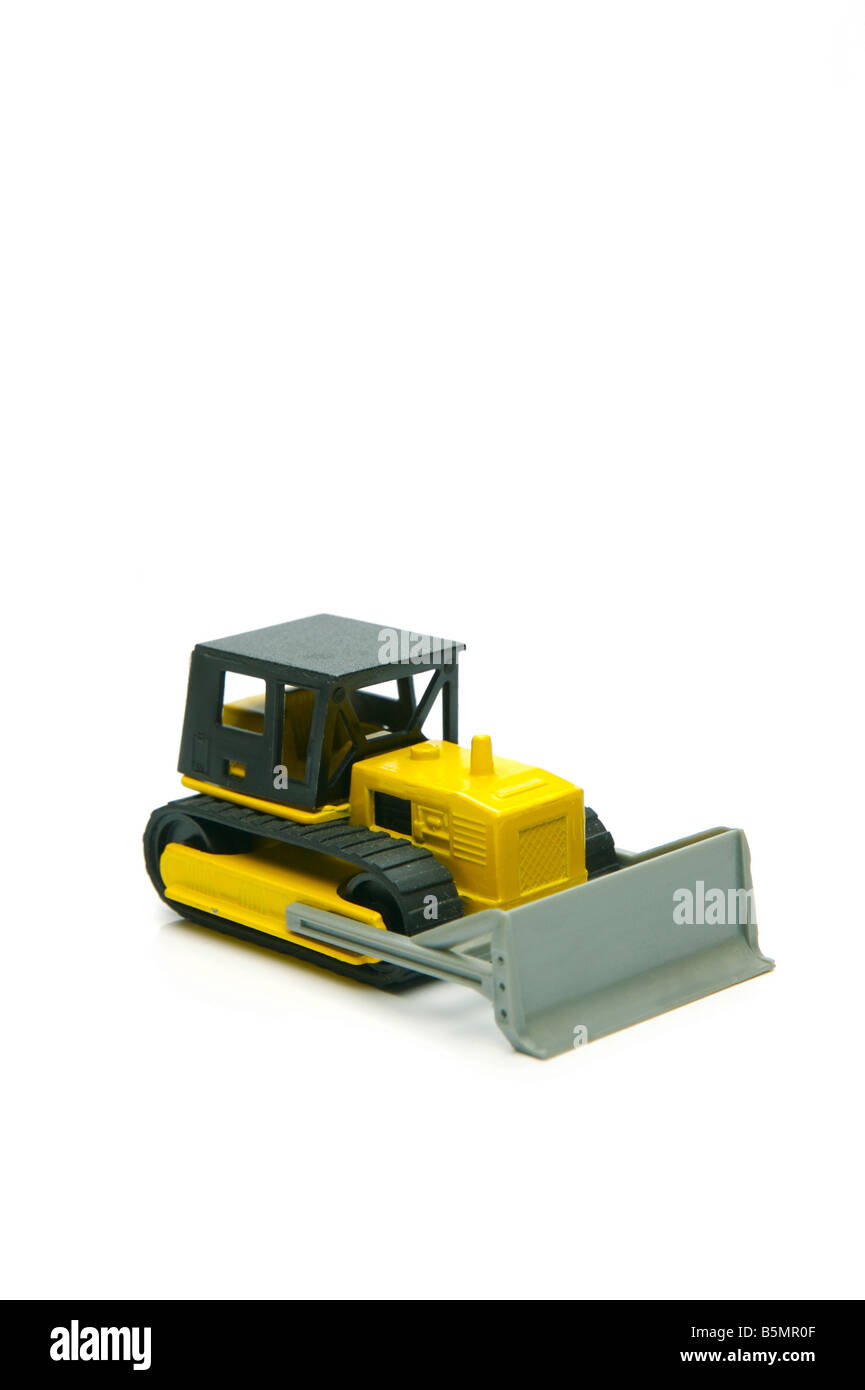 Miniature model earth moving equipment isolated against a white ...