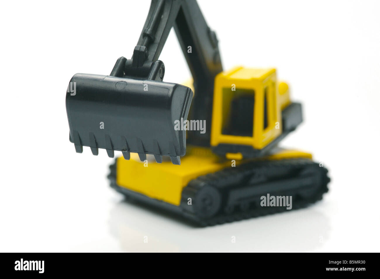 Miniature model earth moving equipment isolated against a white ...