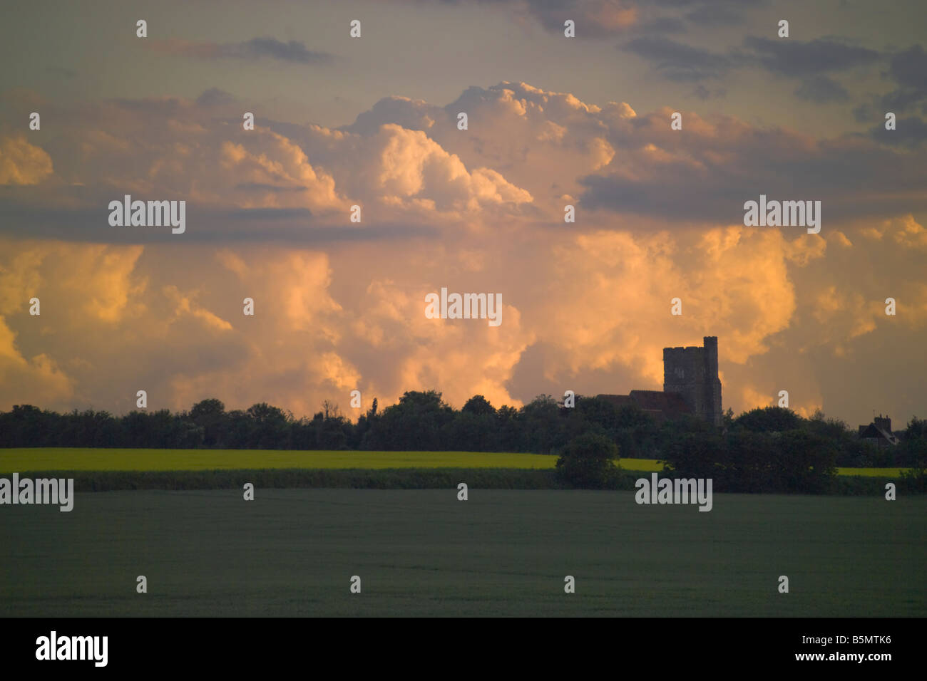 Storm Clouds gather at sunset over the church of St Mary the Virgin ...