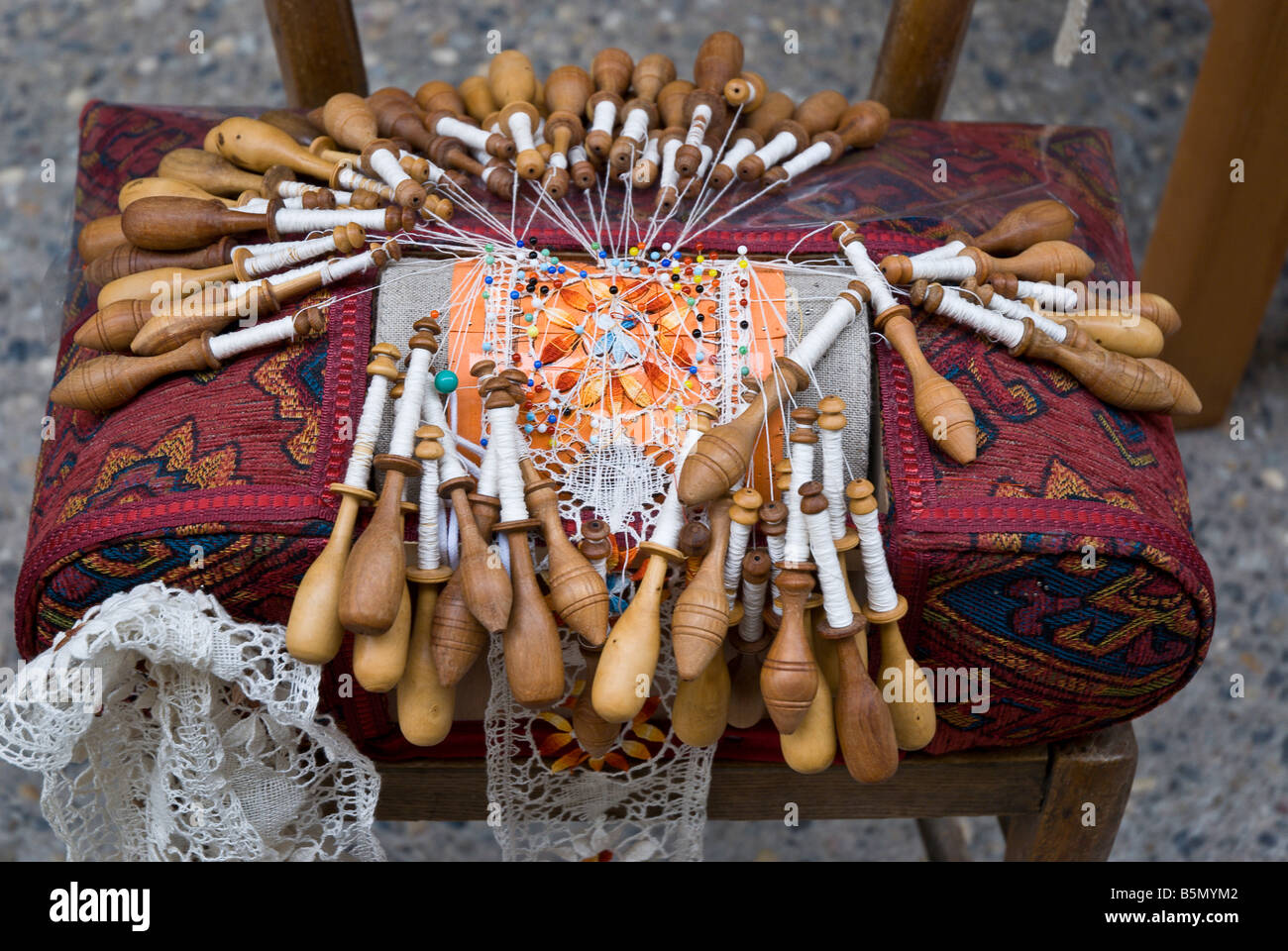 Intricate lace work sits on display on a chair along the street in Le ...