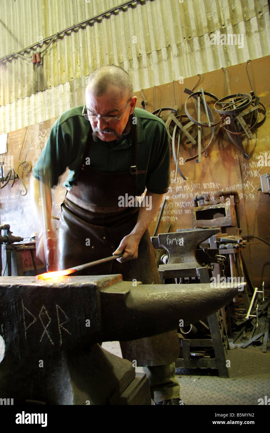 A blacksmith working at an anvil Stock Photo - Alamy
