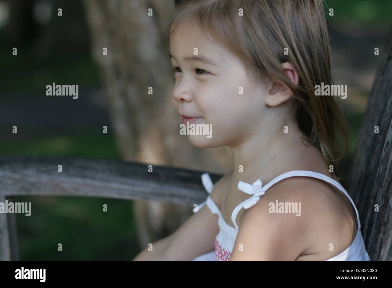 A 2-year-old toddler girl sits on a bench outside at the Dallas ...