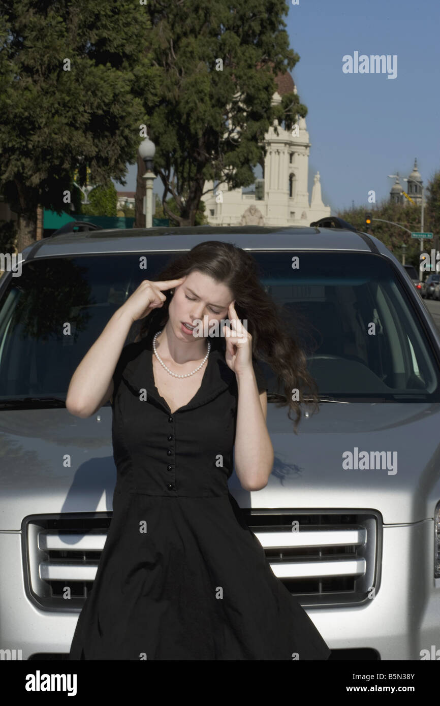 Young woman with headache by Honda Pilot Stock Photo - Alamy