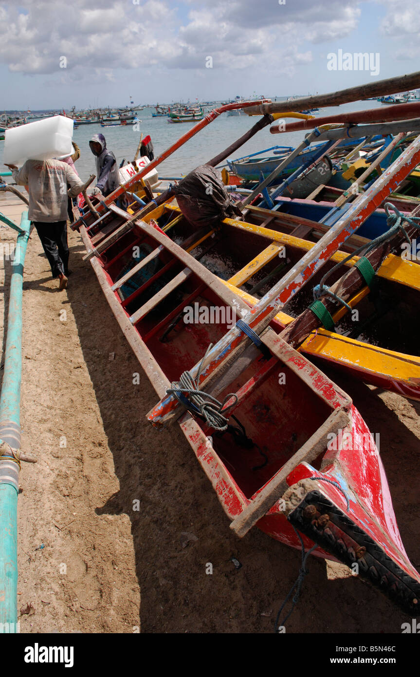 Fisherman carrying big cube ice to the boat, Jimbaran, Bali, Indonesia ...