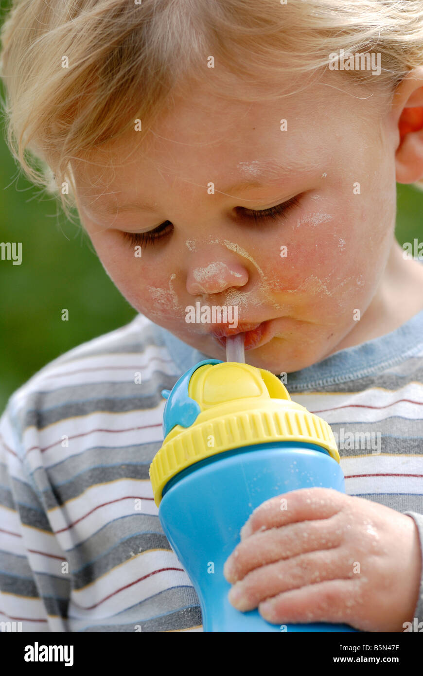 Young boy drinking from beaker hi-res stock photography and images - Alamy