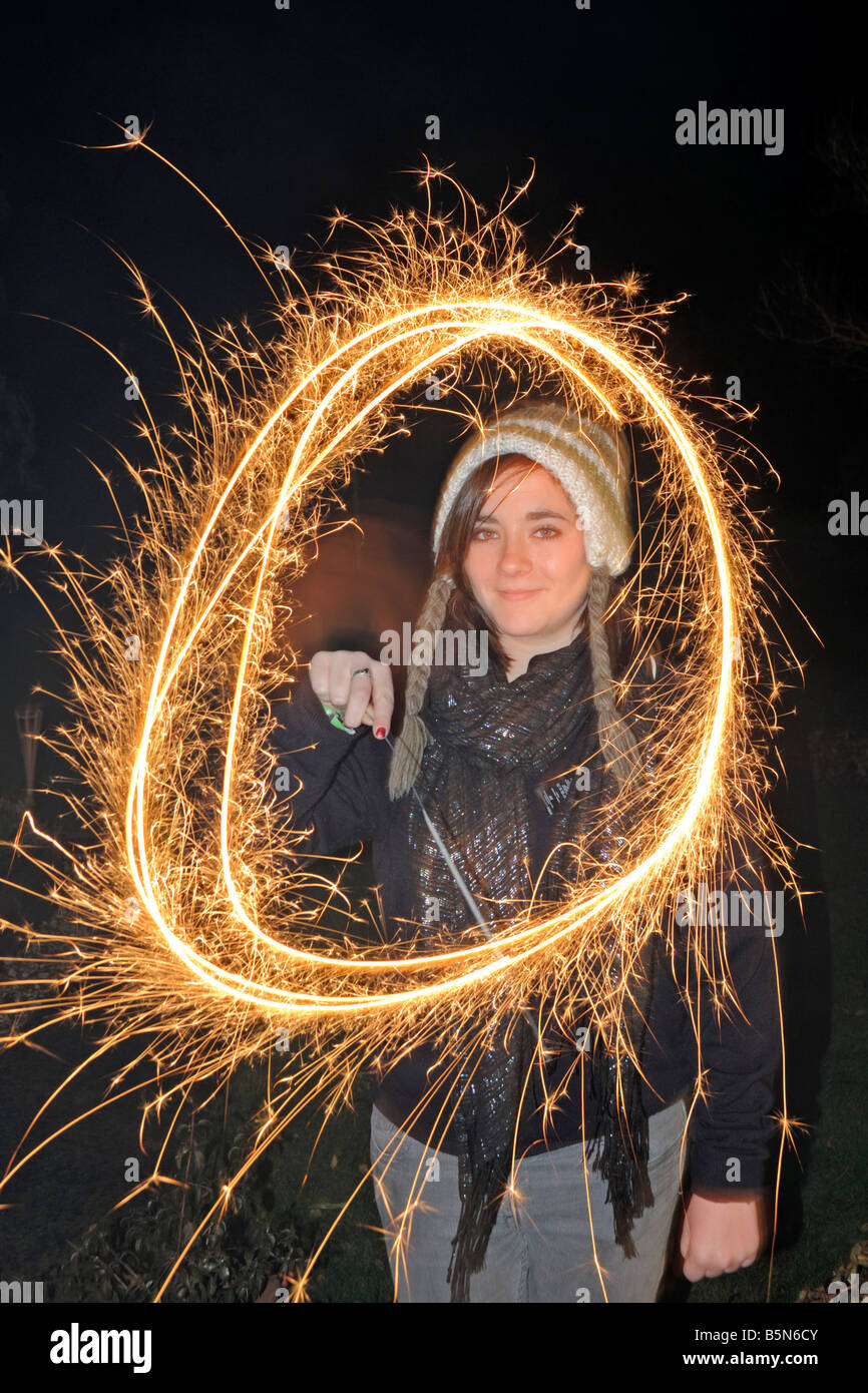 Girl playing with sparkler Stock Photo - Alamy