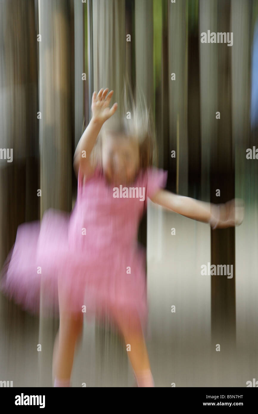 Little girl jumping from a climbing frame Stock Photo - Alamy