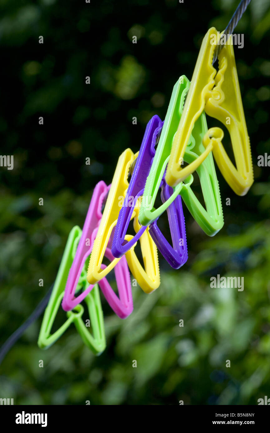 Side view of brightly coloured pegs hanging on a washing line Stock ...