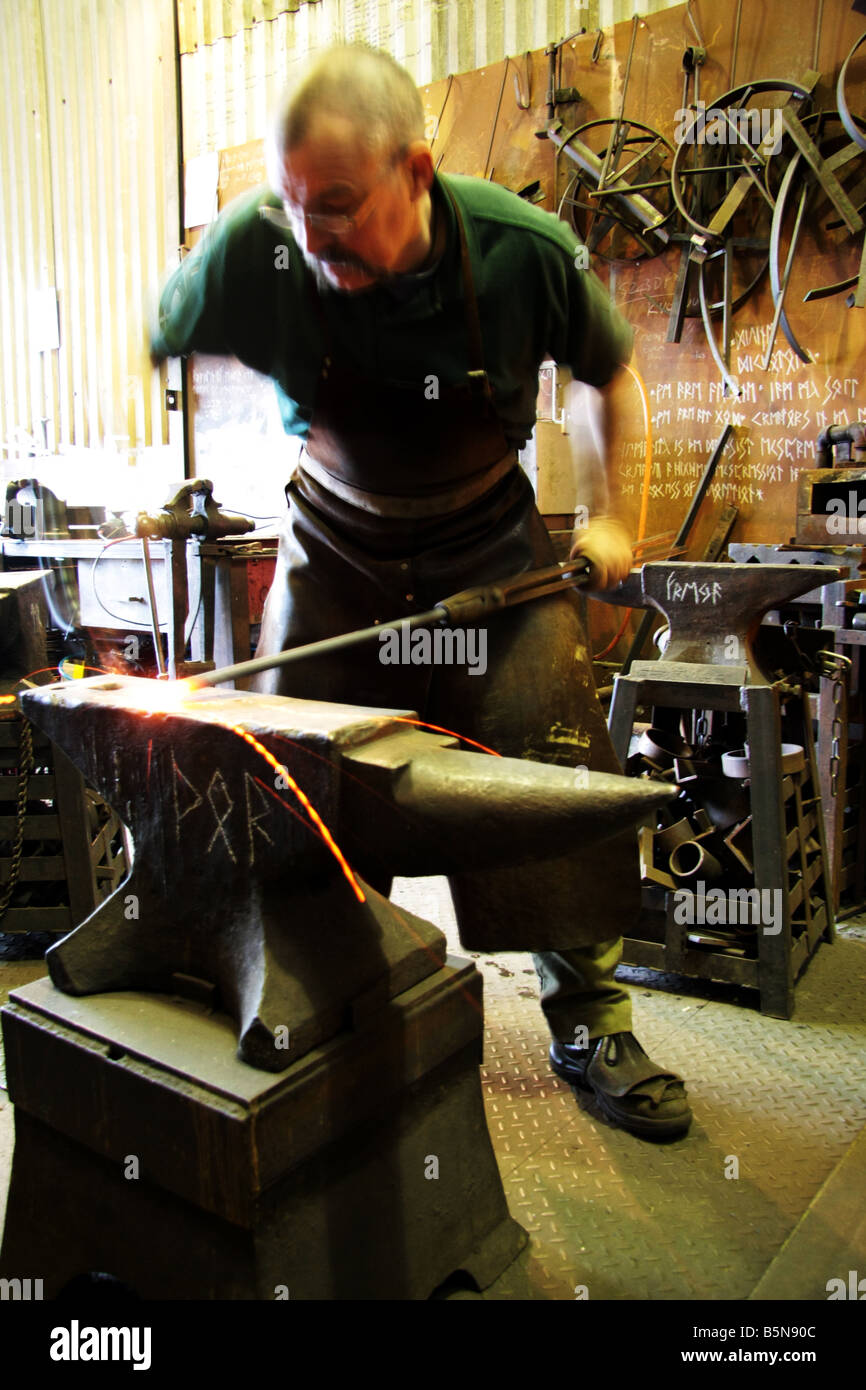 A blacksmith working at an anvil Stock Photo - Alamy