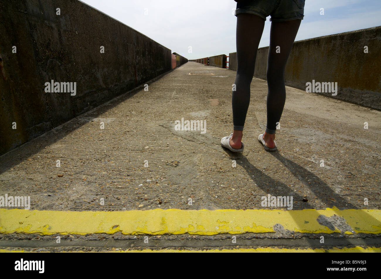 woman crossed yellow line and going to nowhere Stock Photo - Alamy
