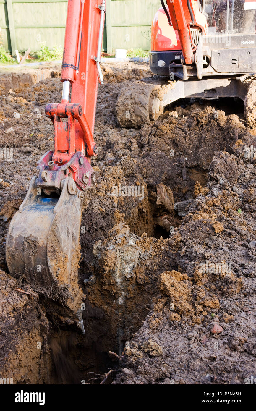 Digging a trench with a digger while preparing the footings to start ...